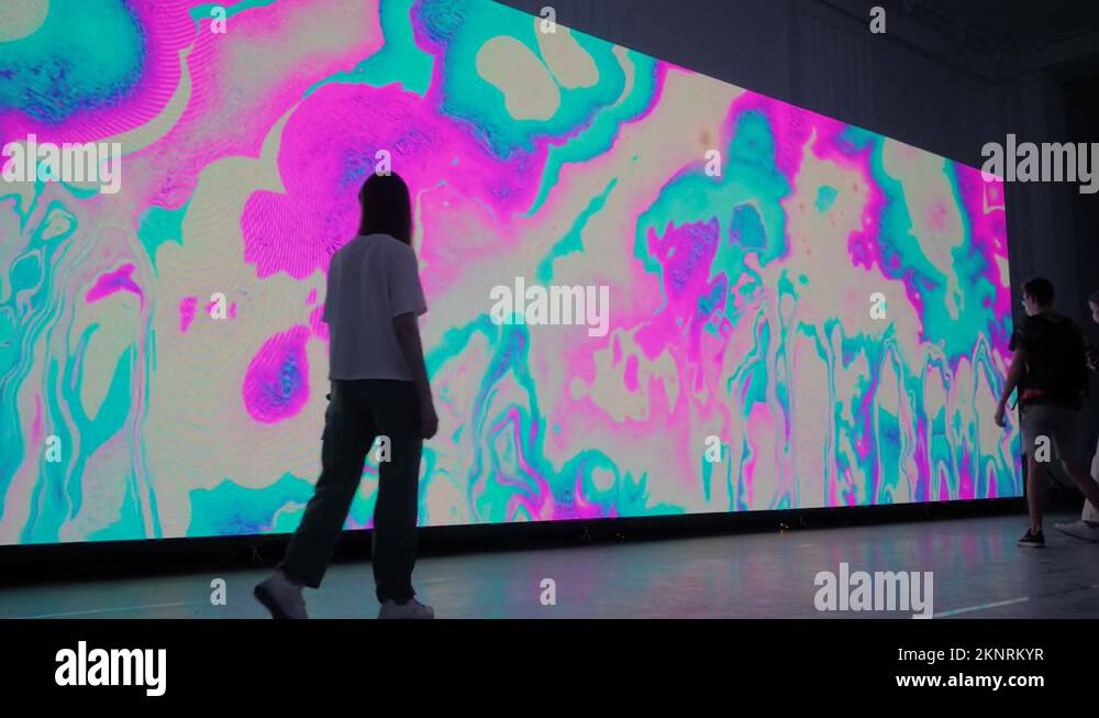 Contemporary art: people moving in front of wide AR display with mirror ...