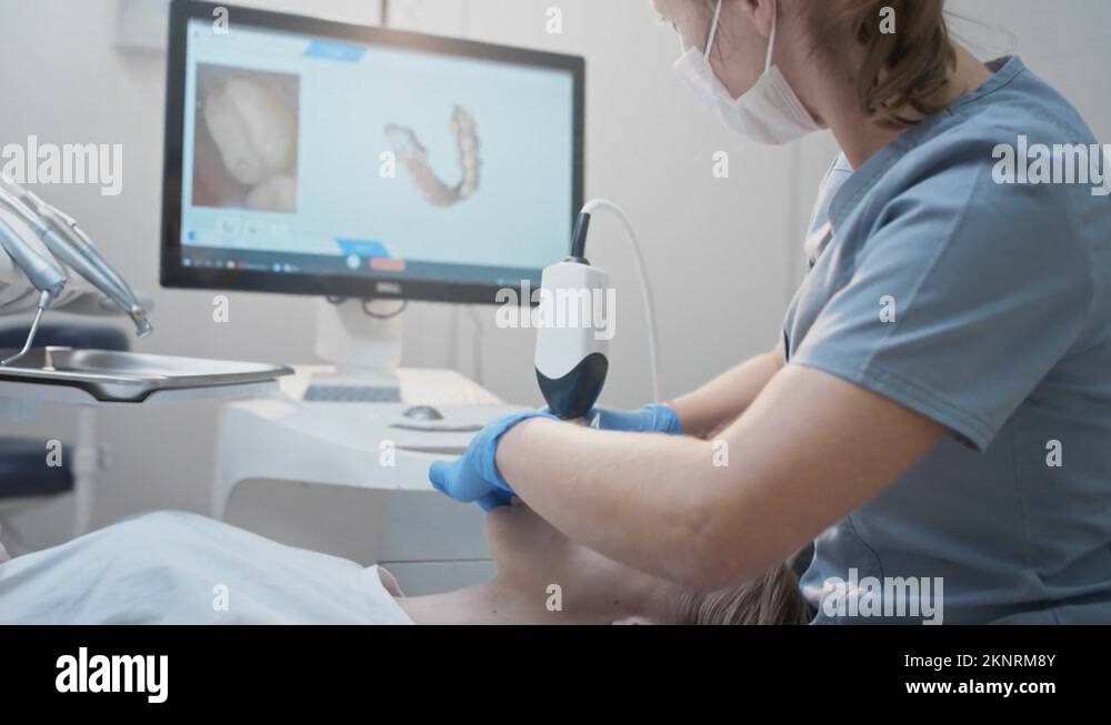 Doctor woman makes a 3d scan of the teeth of a female patient. Creates ...