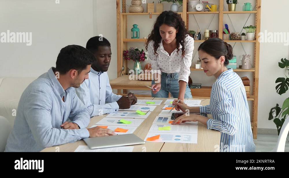 Leader and teammates reviewing statistics sales data shown in charts ...