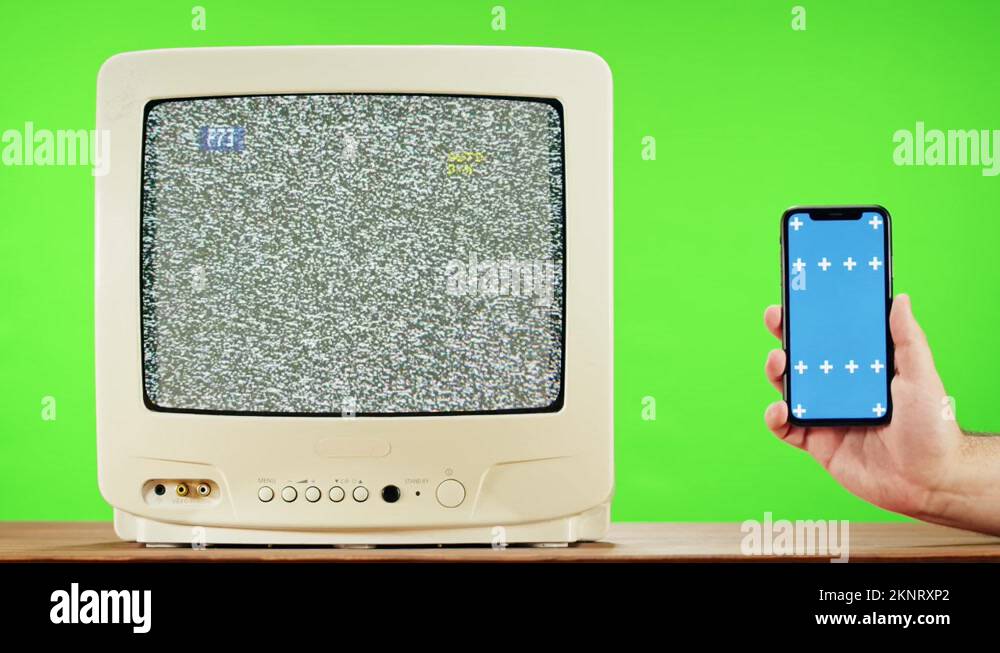 Old television with grey interference screen on green background and ...