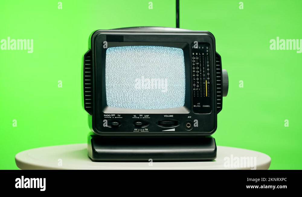 Small old television with grey interference screen on chroma green ...