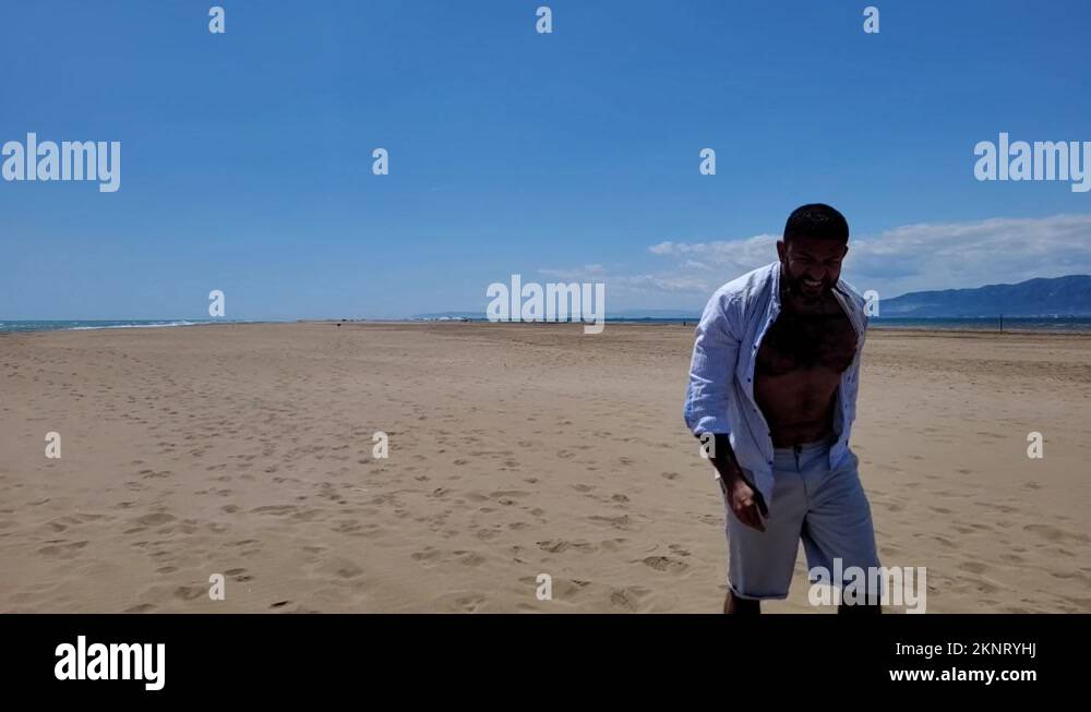 Man on beach open Stock Videos & Footage - HD and 4K Video Clips - Alamy
