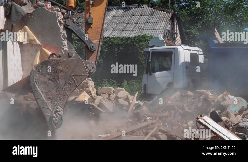 Process of demolition of old building dismantling. Excavator breaks old ...