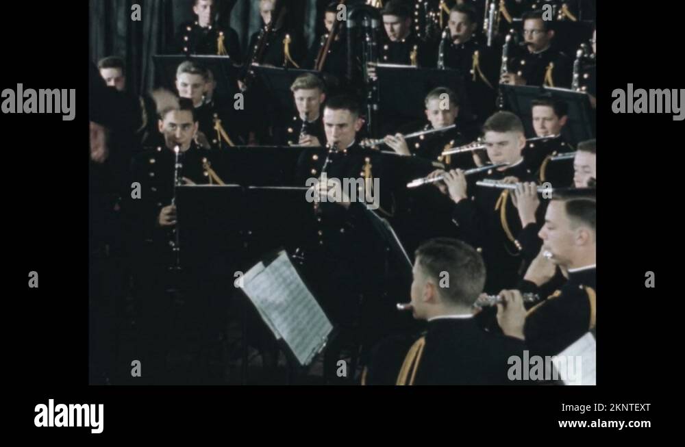 1950s: Conductor conducting orchestra. Musicians playing woodwind ...