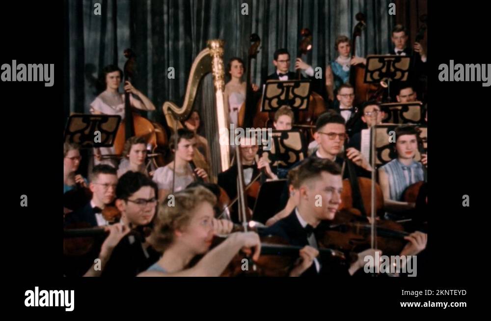 1950s: Hand holding clapperboard, clapping. Musicians playing ...