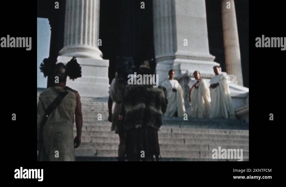 1960s: Medieval soldiers walk up steps of Roman building. Soldiers talk ...