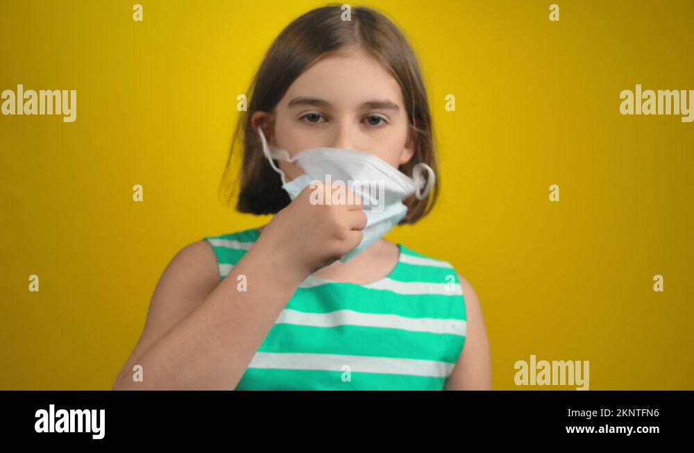 Cute girl takes off a mask during covid and throws it away with a happy ...