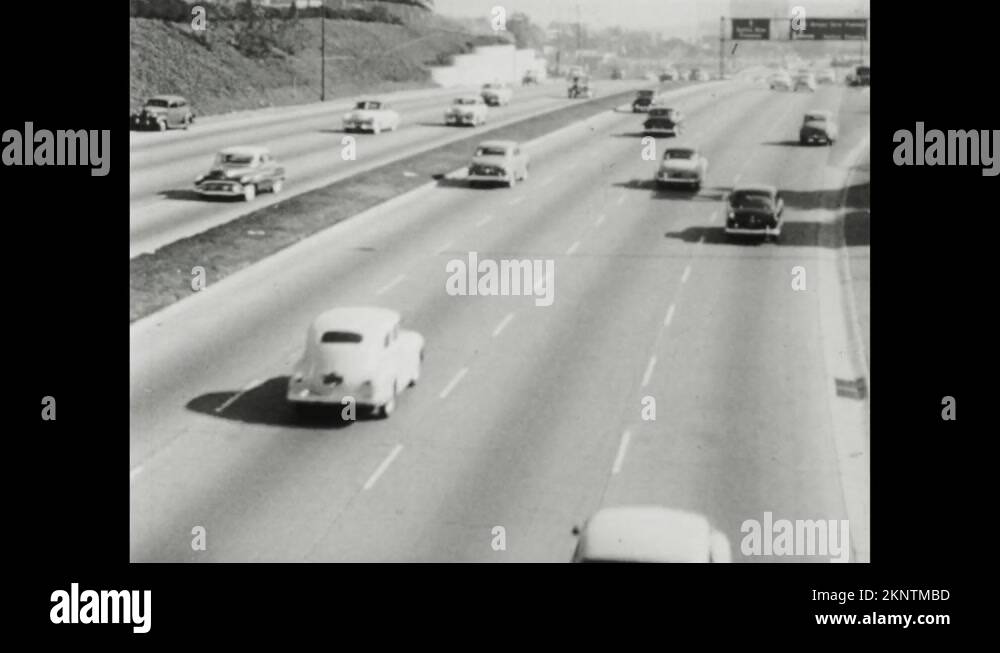 1950s: Modern divided multi-lane highway with traffic. View from ...