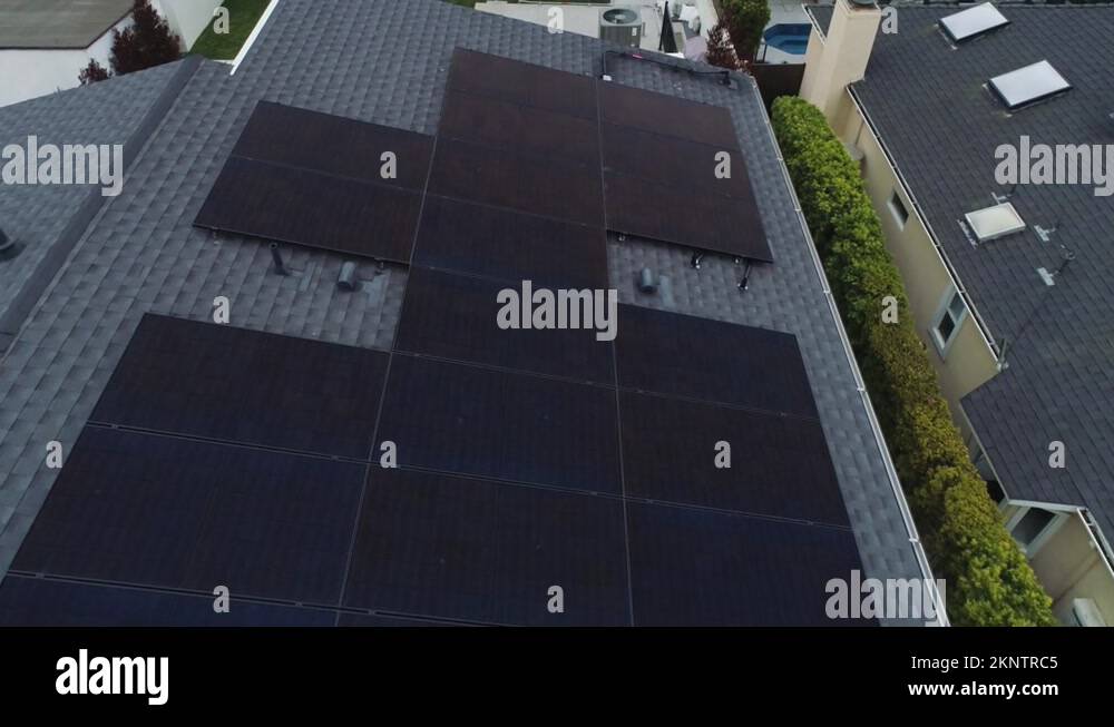 Slow aerial flyover solar panel rooftop in Los Angeles California on an ...
