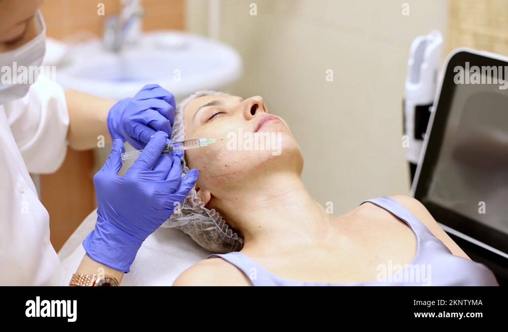 Beautician hands in gloves makes an injection of facial aging into female skin Stock Video ...