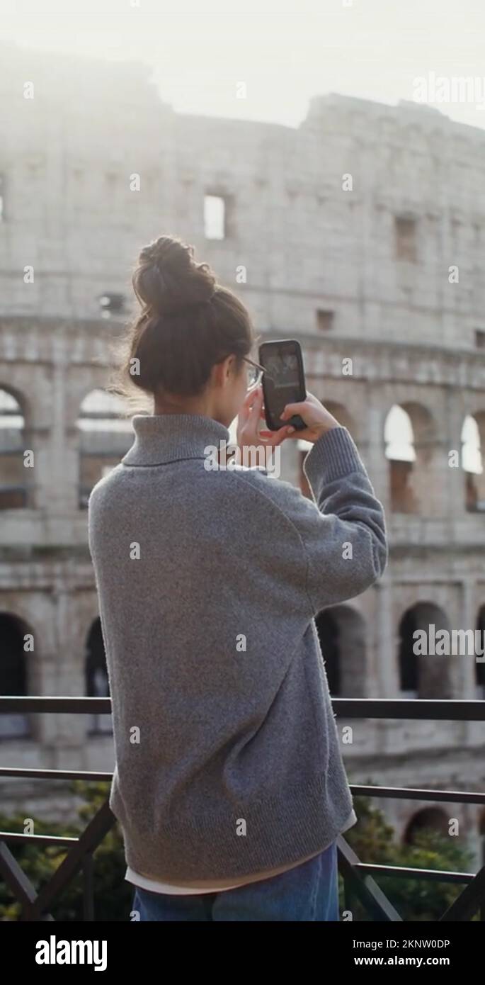 A woman takes photographs of sights of Rome on a mobile phone near the ...