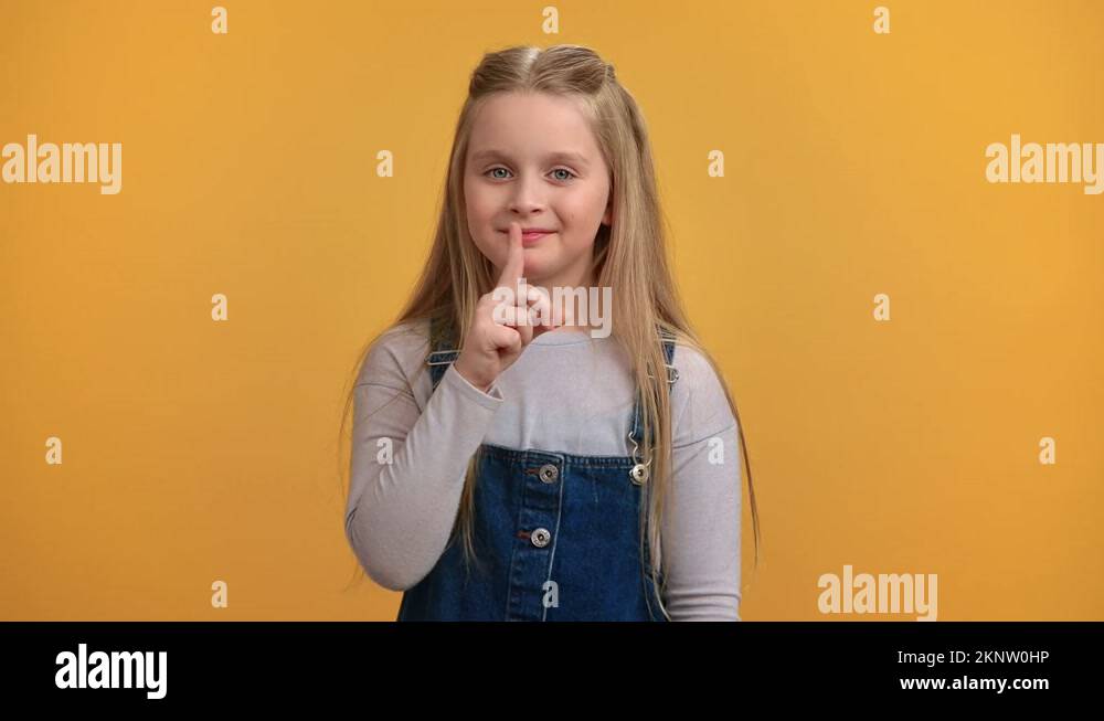 Portrait baby girl posing with index finger on lips gesturing silence shhh noise Stock Video ...