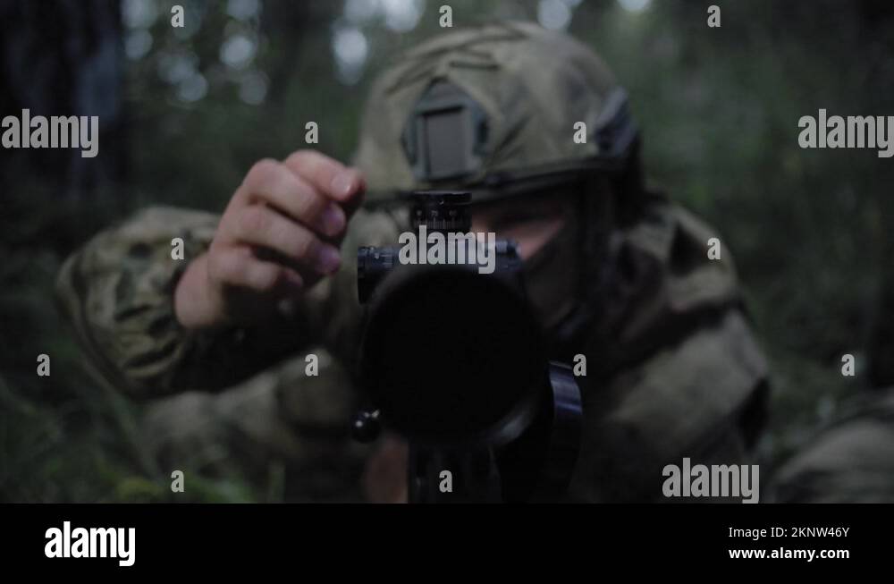 Soldier on military operation with sniper rifle in an ambush in dense ...