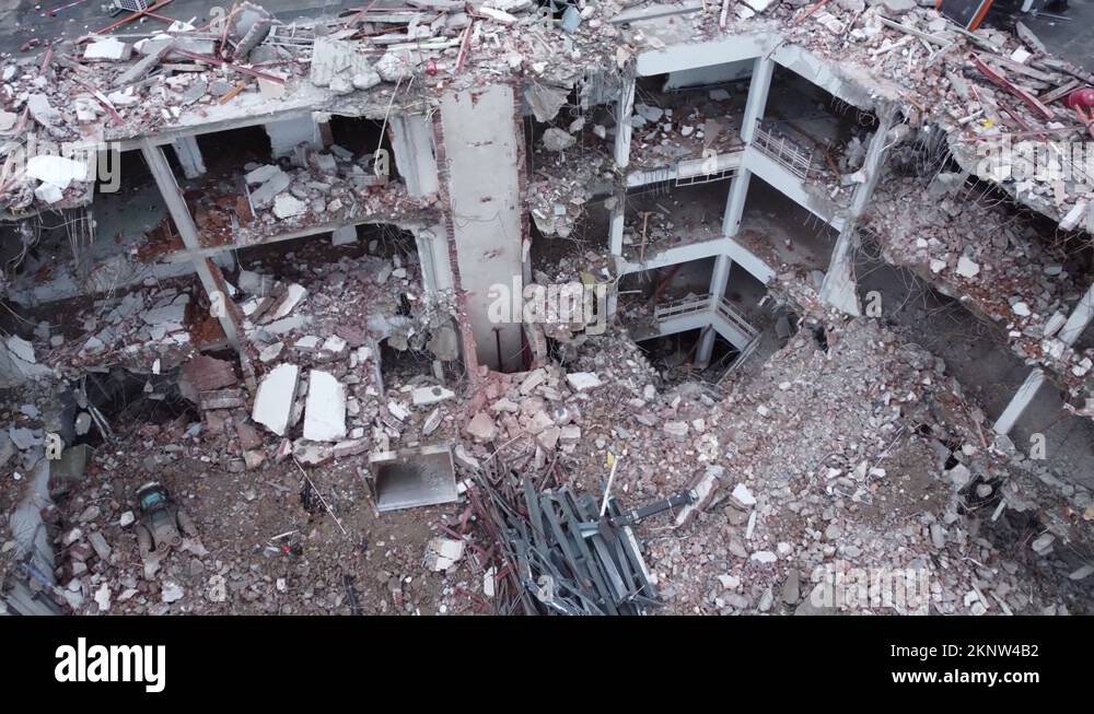 Demolition of a police station using building hydraulic shears, aerial ...