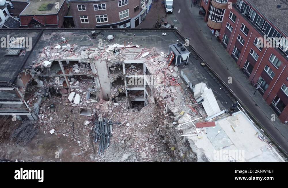 Demolition of a police station using building hydraulic shears, aerial ...