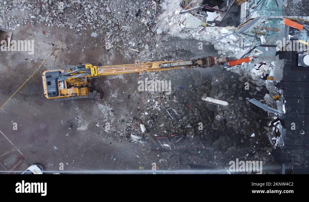 Demolition of a police station using building hydraulic shears, aerial ...