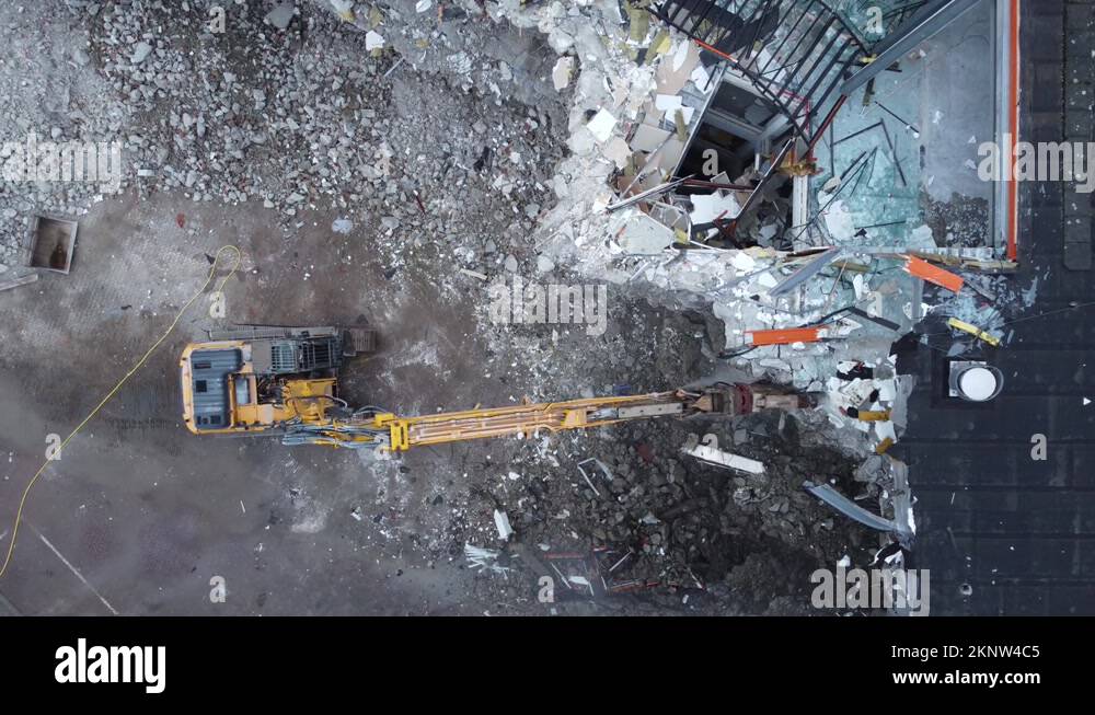 Demolition of a police station using building hydraulic shears, aerial ...