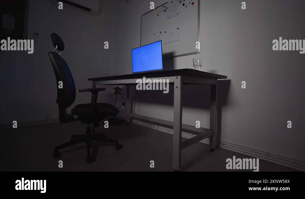 Editable blue screen laptop on a desk in an office,whiteboard on wall ...