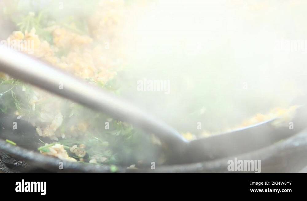 Man is frying rice with egg and vegetables in pan, Thai famous food ...
