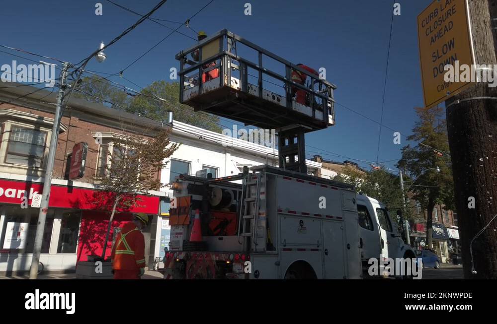 Hydro workers doing maintenance on overhead streetcar lines on Queen ...