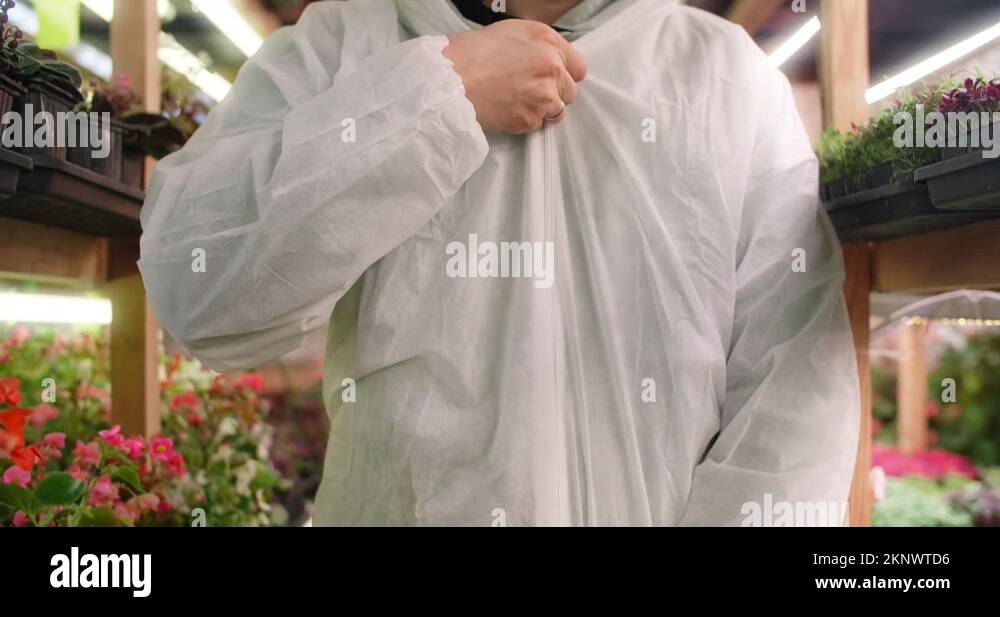Farmer zippers up his work overalls, vertical farming microgreens ...