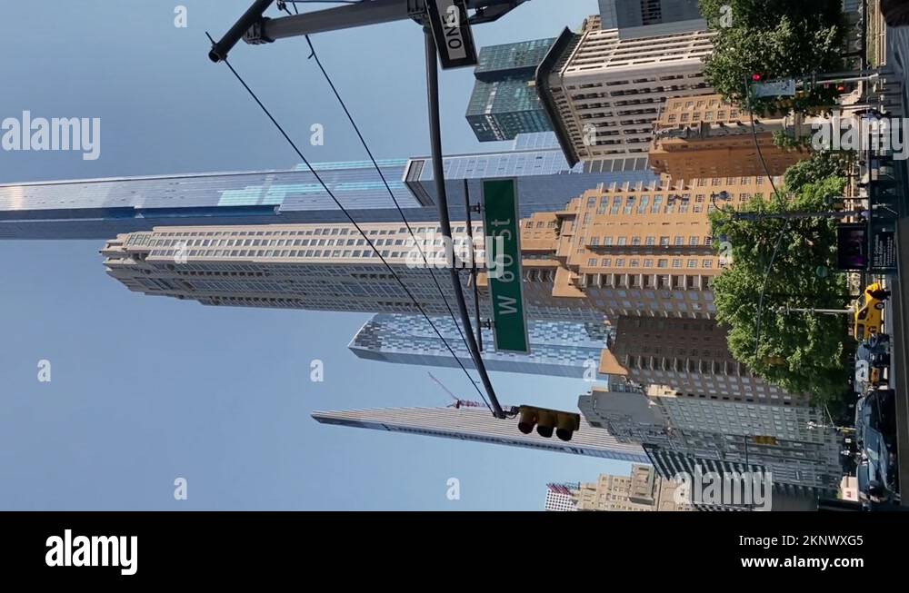 Traffic signs, one way arrow, street name 60th St., traffic light in ...
