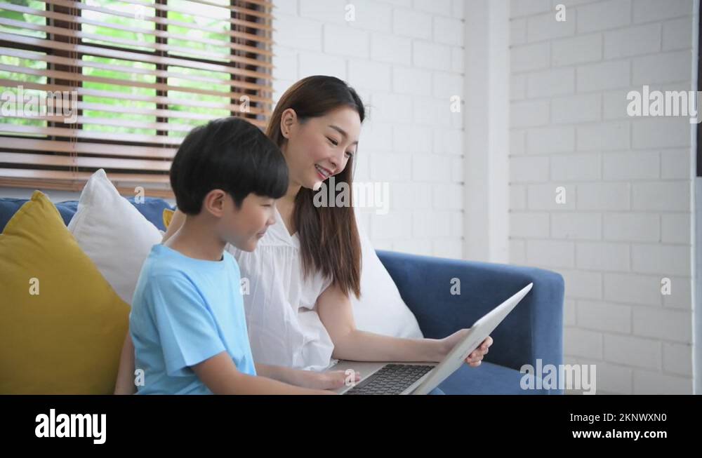 Family concept of 4k Resolution. Mother and son are using computers to ...