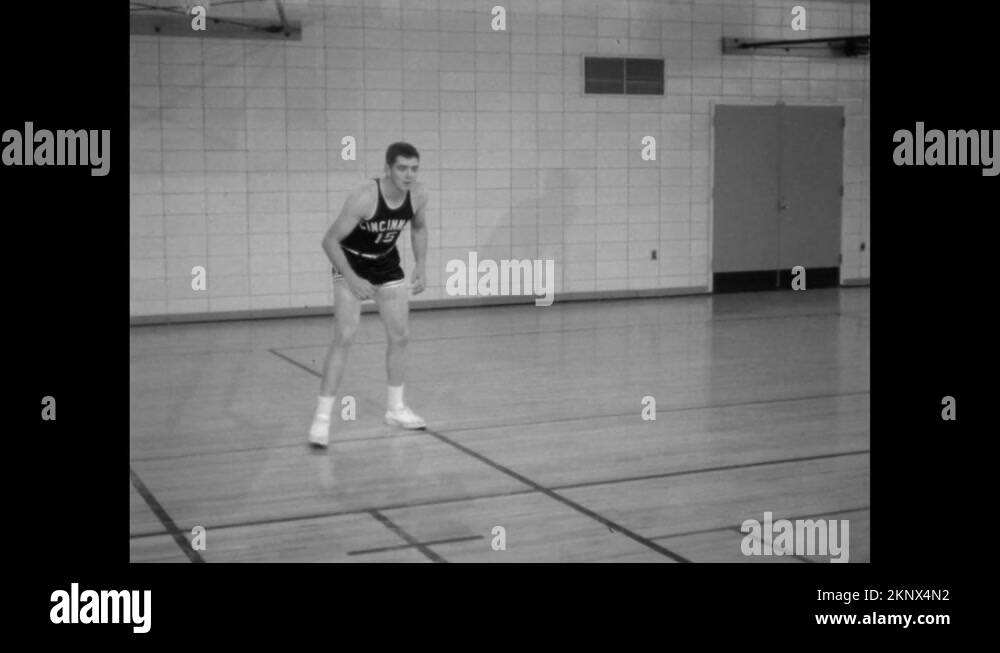 1960s: Gym. Basketball court. Men play basketball backwards. Players ...