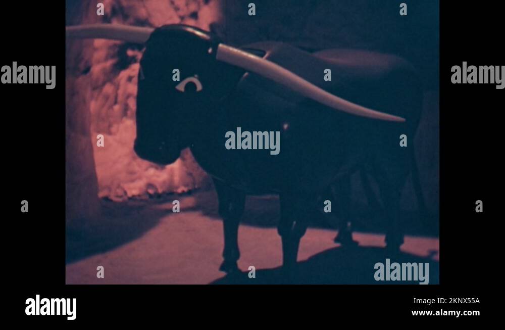 1950s: A bull puppet stands in a cave and lifts its head. It bows and ...