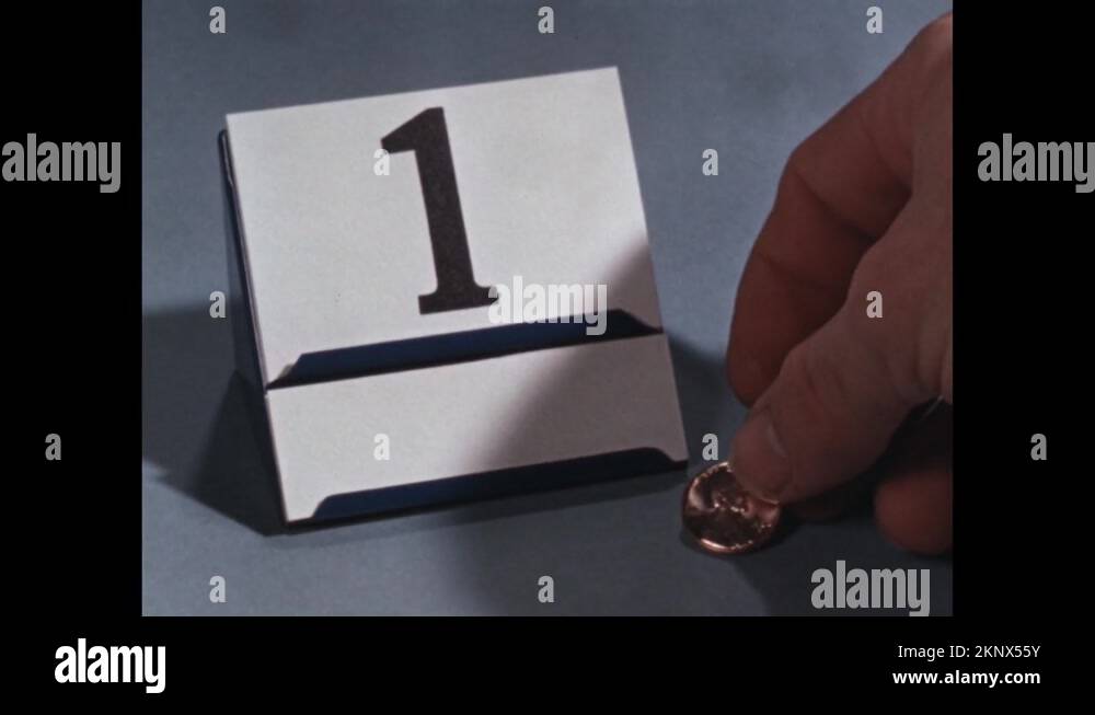 1960s: Number cards on stand, hand puts cards on stand, sets down ...