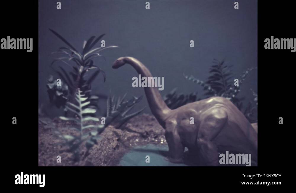 1950s: Model of brachiosaurus eating leaves. Wave in an aquarium Stock ...