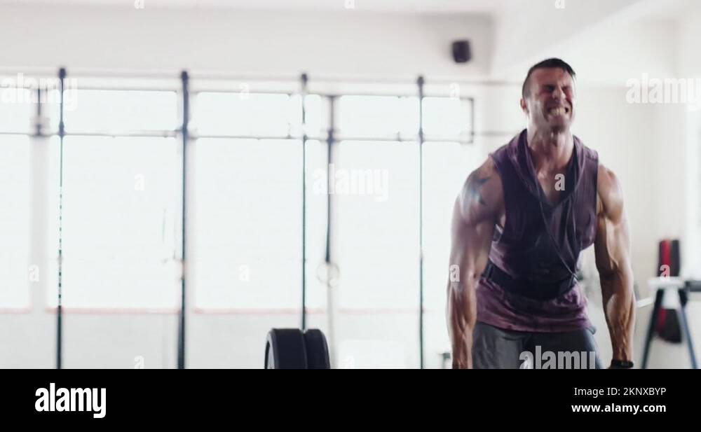 Maximise those muscles. 4k video of a muscular young man lifting ...