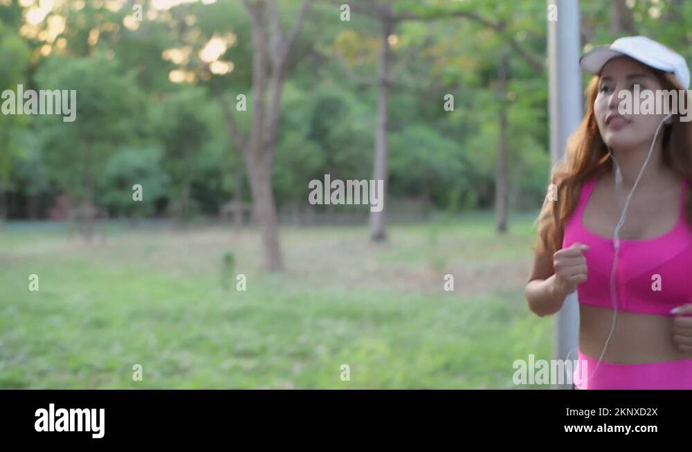 Exercise concept of 4k Resolution. Asian woman jogging in the park ...