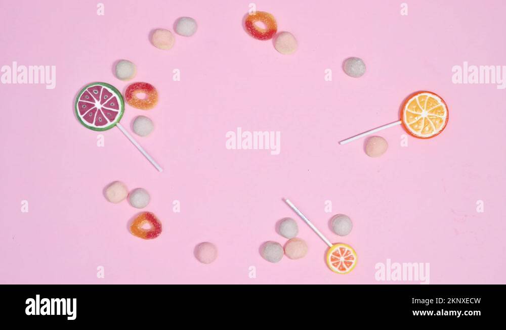 Gummy candies, chocolate candies and lollypops appear in circle. Stop ...