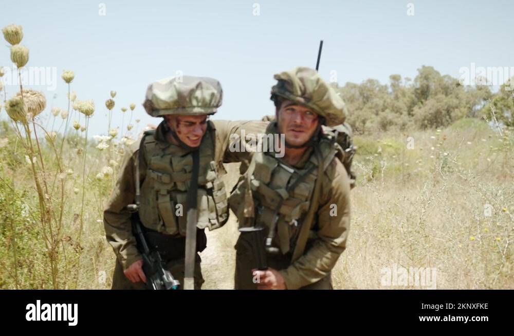Two injured soldiers walking side by side talking each other through ...