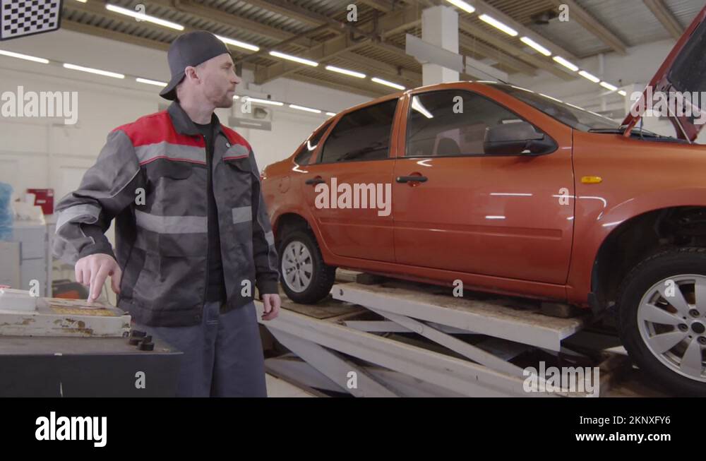 Mechanic Lifting Car on Scissors Lift in Service Garage Stock Video ...