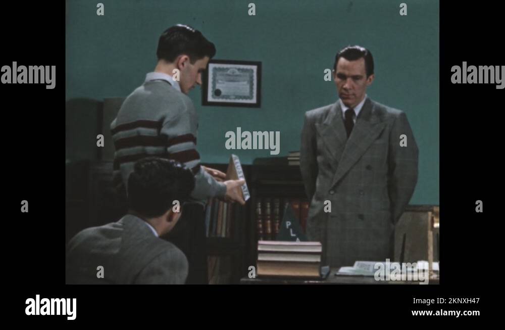 1950s: Boys stand in school hallway and talk while students exit ...