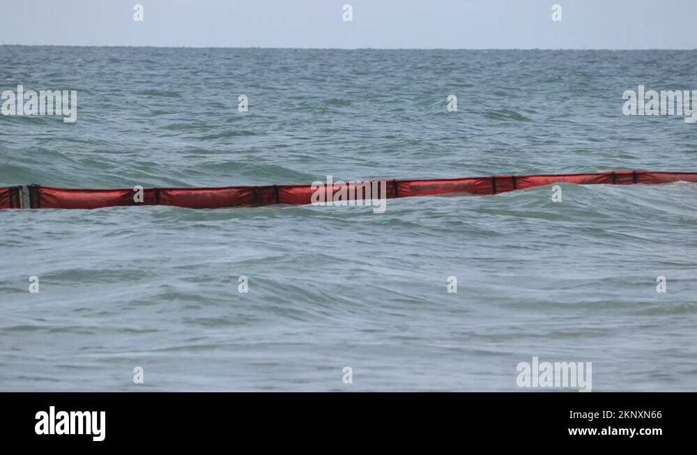 Inflatable Oil Boom Barrier Floating In The Ocean To Block The Oil ...