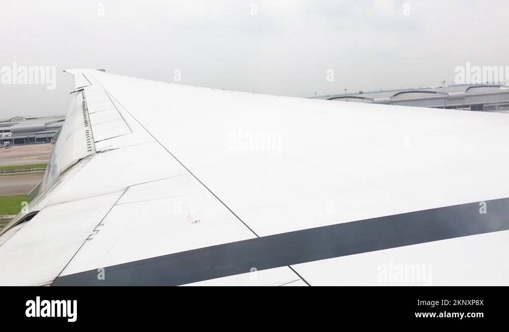Looking through window aircraft during flight next to the wing with sky ...