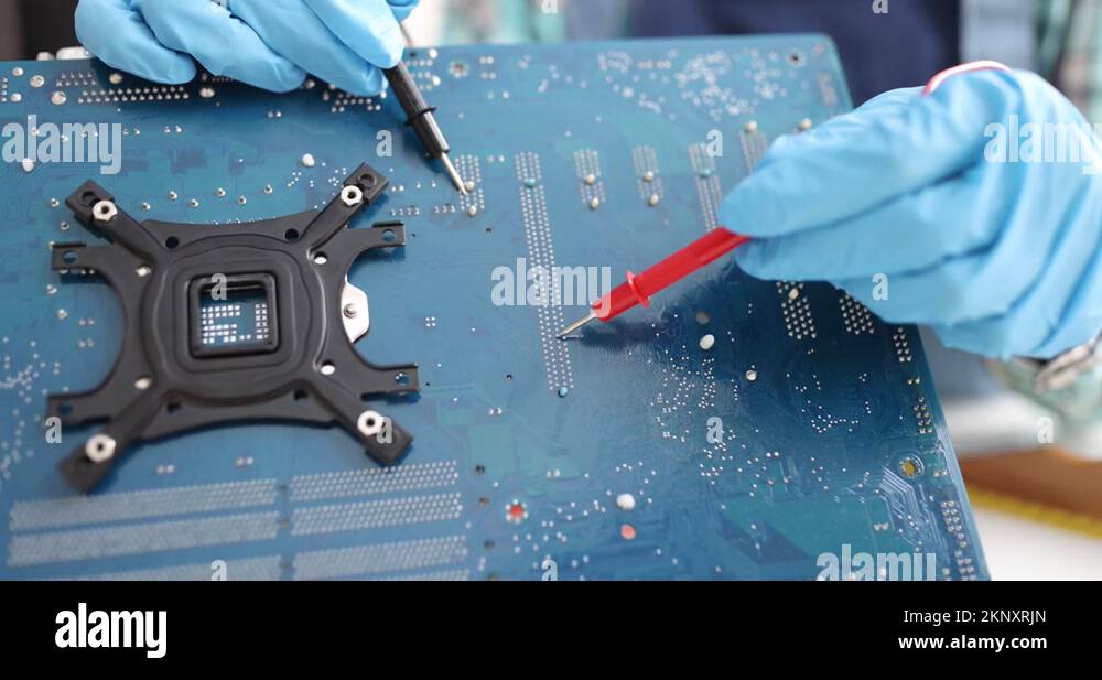Repairman diagnosing breakdown in computer motherboard using tester ...