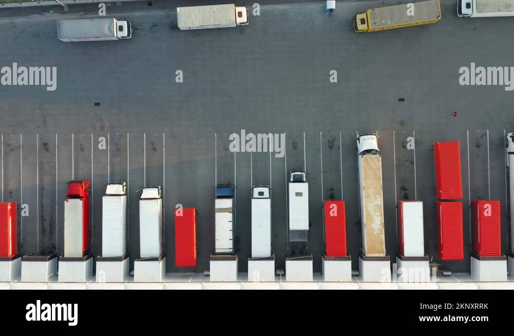 Semi-trailers trucks standing at warehouse ramps for loading and ...