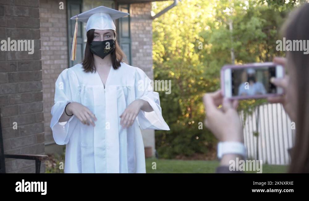 High school girl wearing cap and gown with face mask 2020 Stock Video ...