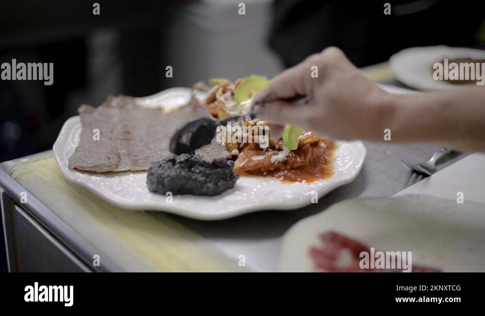Chef sou-chef cook preparing a traditional mexican dish called ...