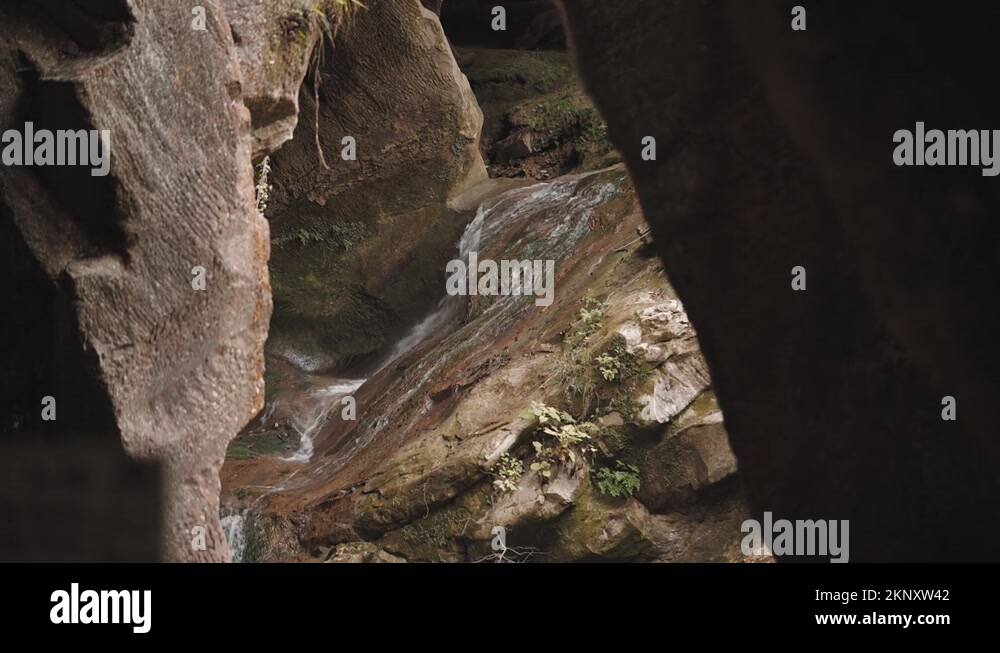 Close up of a spring of water in bed of rocks inside a Cajeron caves ...
