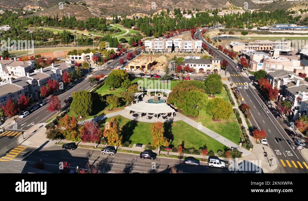 Rotating Drone view of a square shape park with a fountain in San Elijo ...