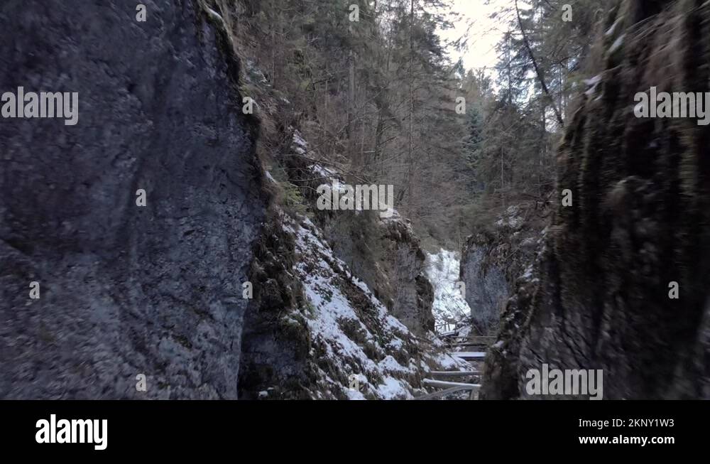 Backward Through Narrow Gap Between Rugged Cliffs With Wooden Bridge In ...