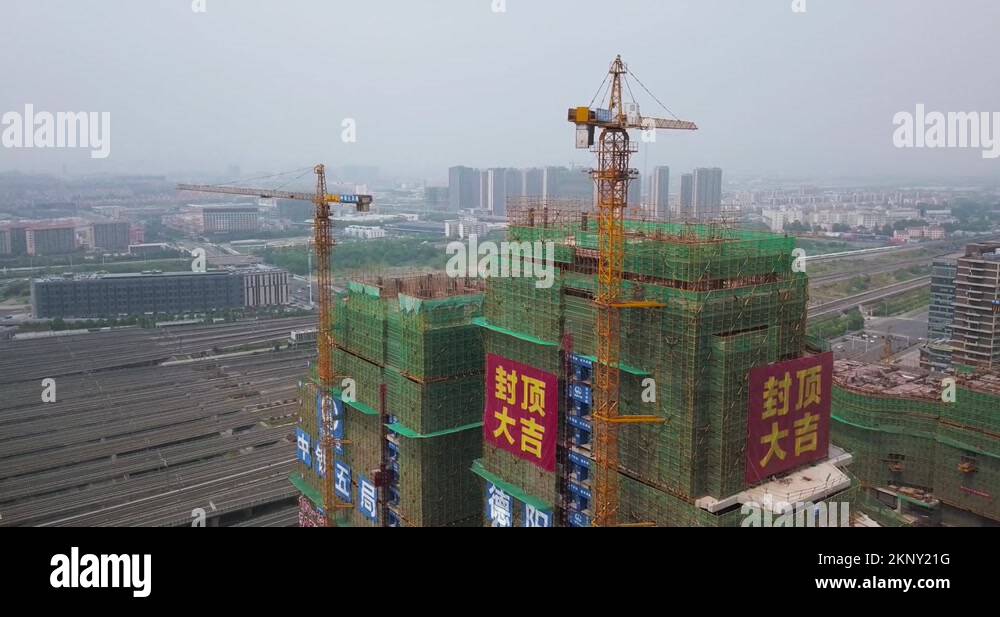 Tall construction towers and cranes high above a new high speed rail ...