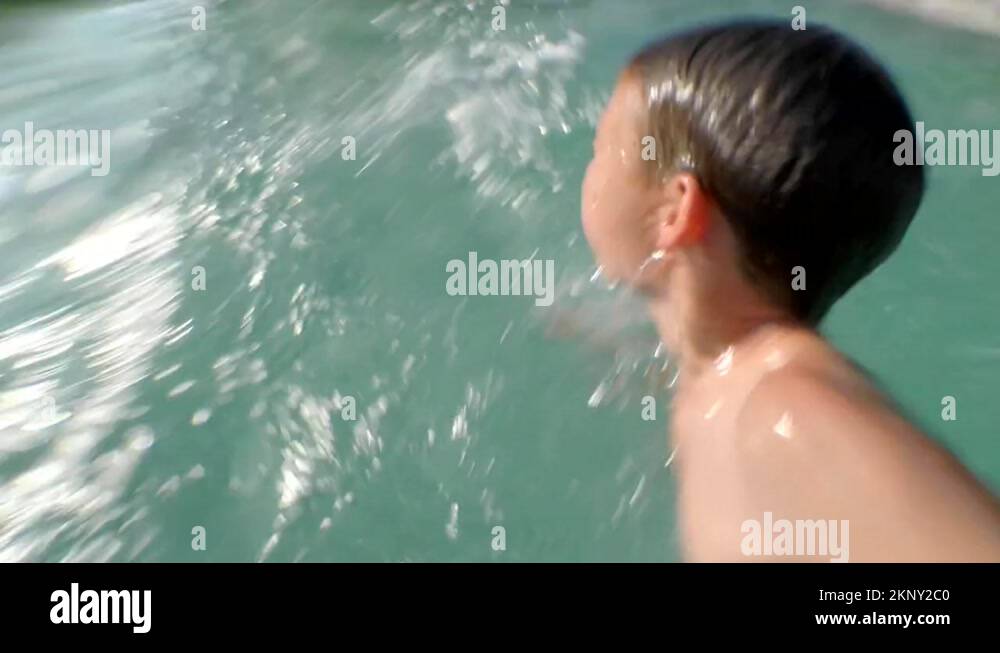 Baby boy in the water while relaxing in swimming pool. Child body ...