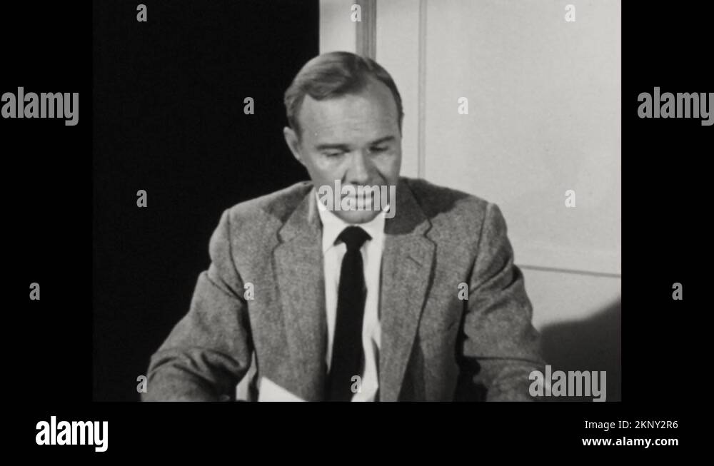1960s: In office, manager behind desk and employee enters and talks ...