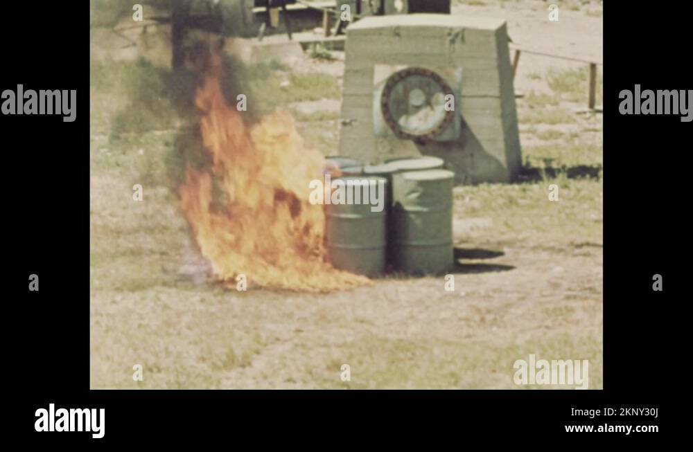 1970s: man laying stacks of brick then sprinkler on top of them ...